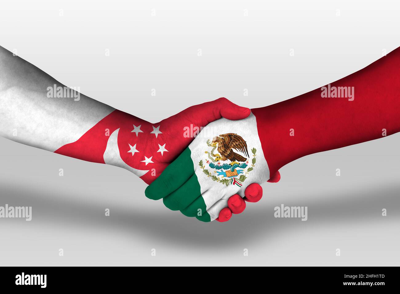 Handshake between mexico and singapore flags painted on hands ...