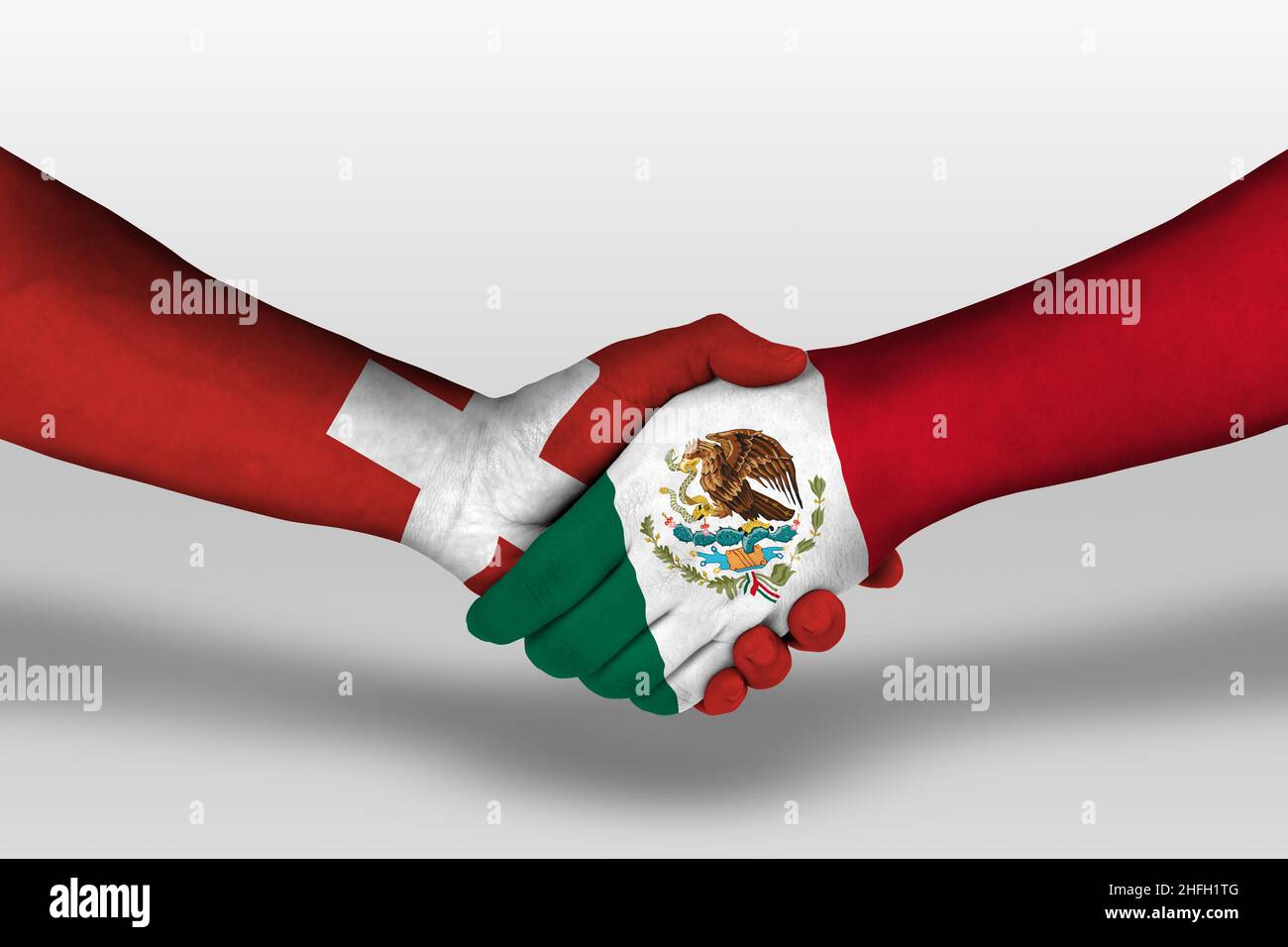 Handshake between mexico and switzerland flags painted on hands ...