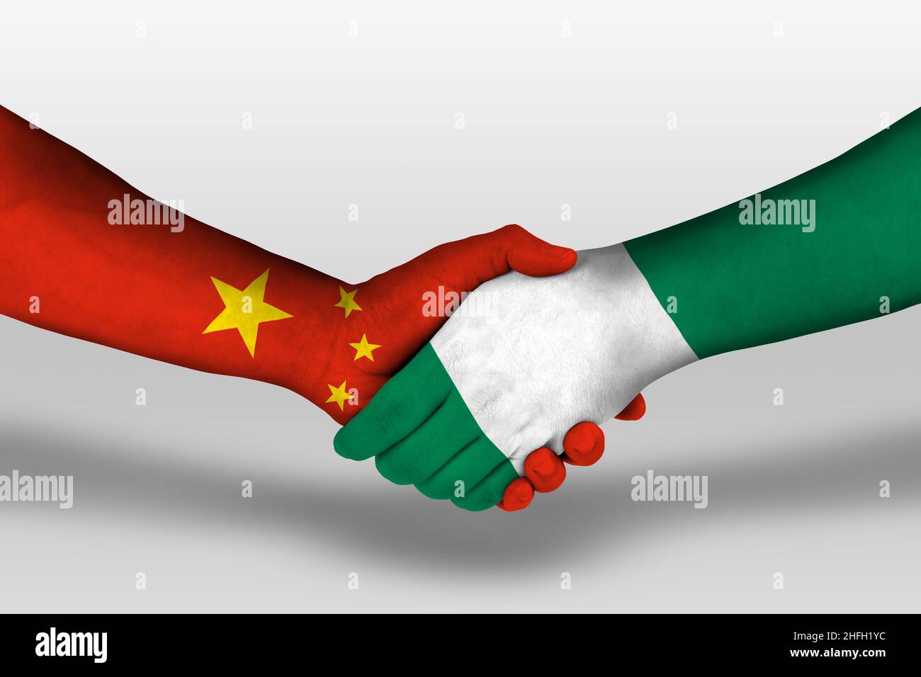 Handshake between nigeria and china flags painted on hands ...