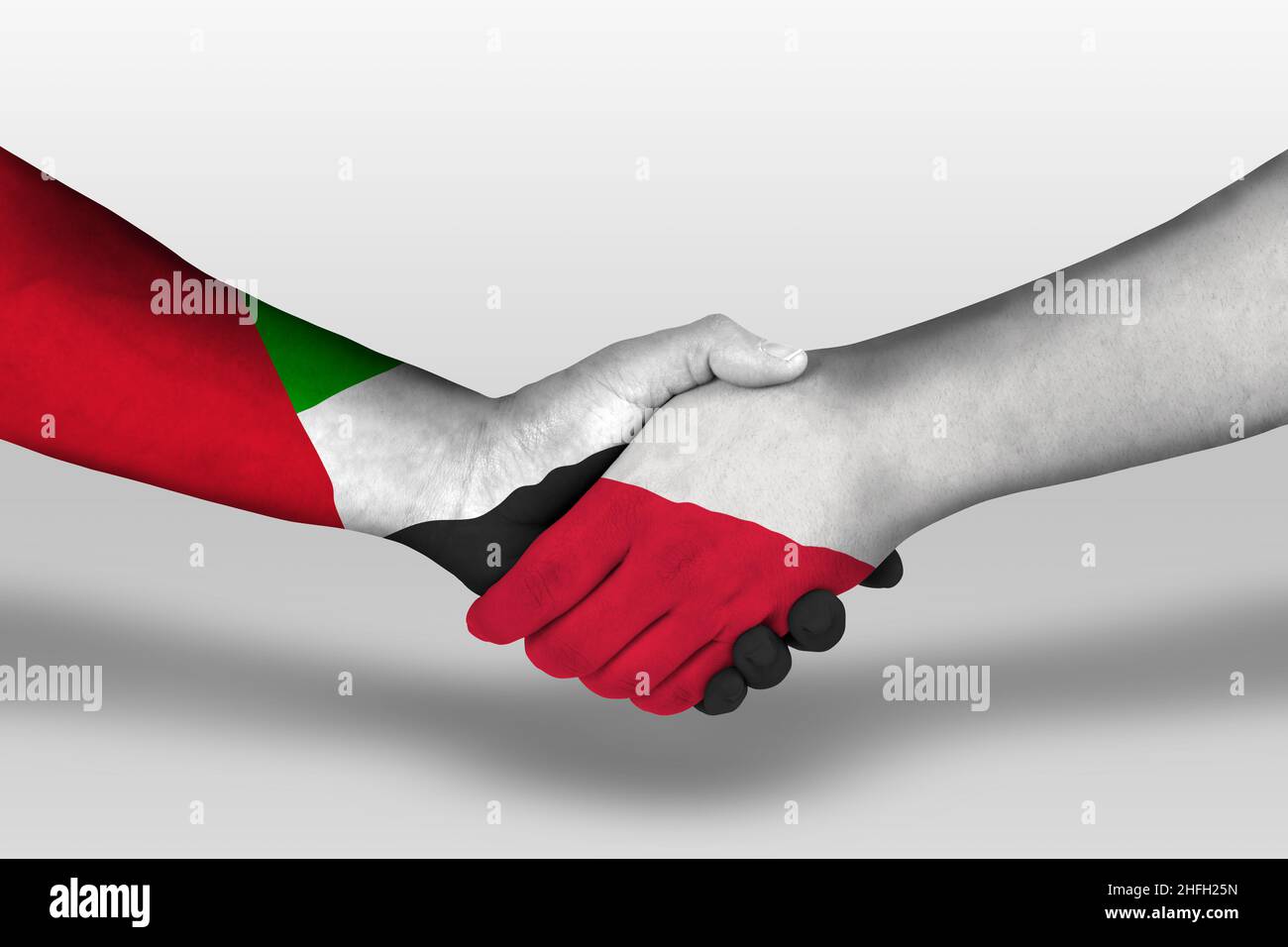 Handshake between poland and united arab emirates flags painted on ...