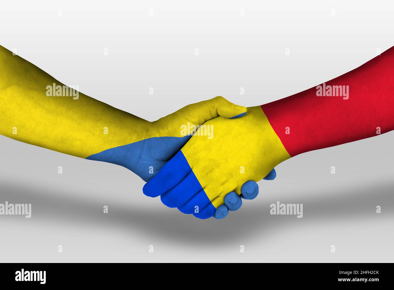 Handshake between romania and ukraine flags painted on hands ...