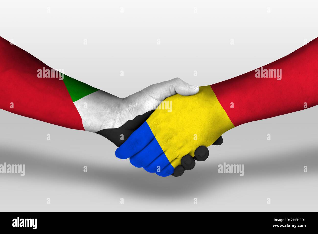 Handshake between romania and united arab emirates flags painted on ...