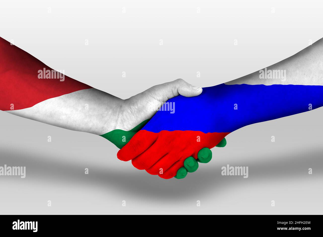 Handshake between russia and hungary flags painted on hands ...