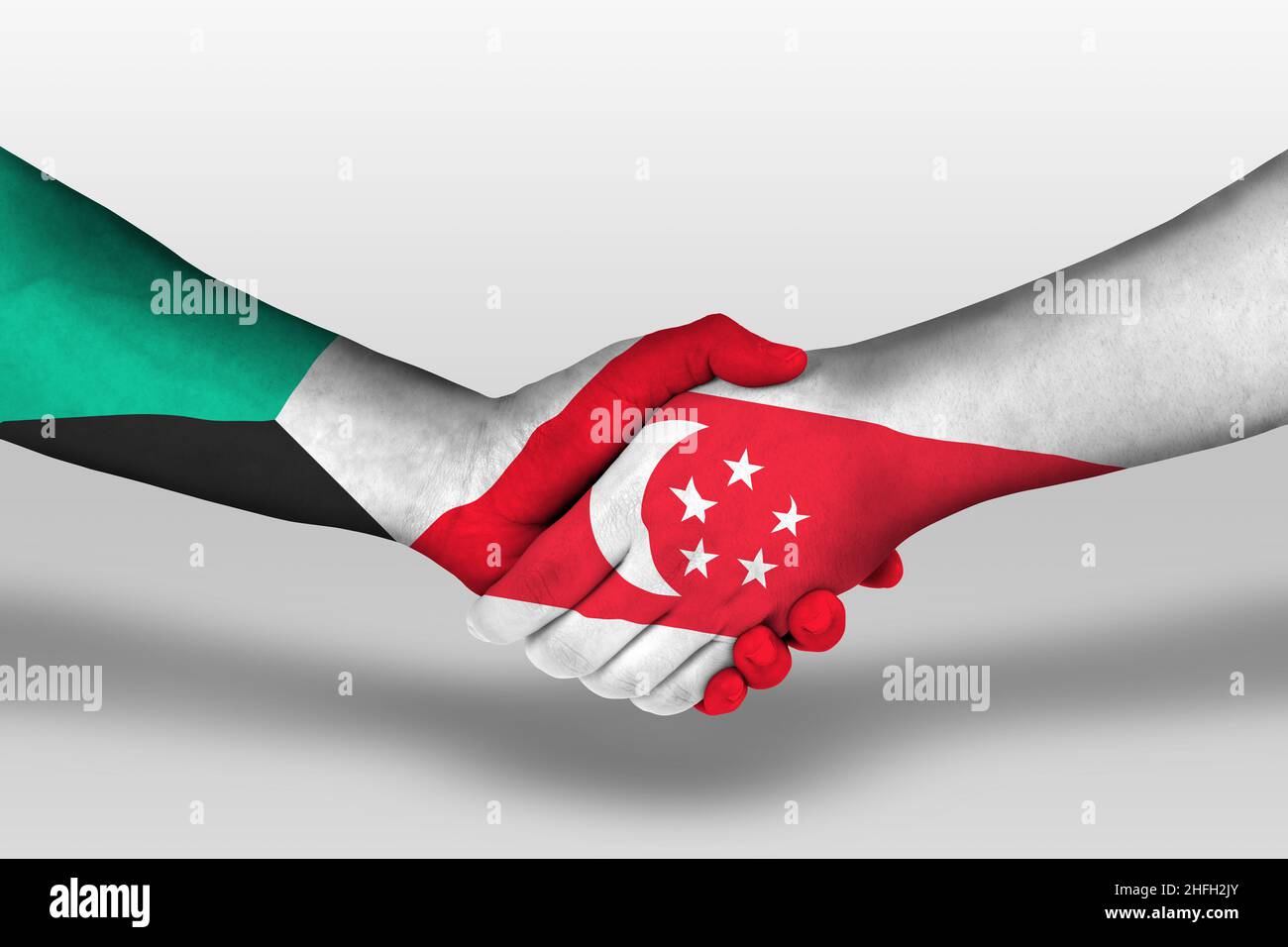 Handshake between singapore and kuwait flags painted on hands ...