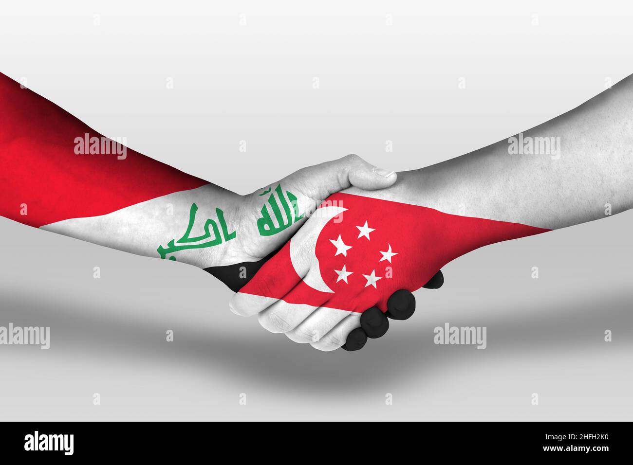 Handshake between singapore and iraq flags painted on hands ...