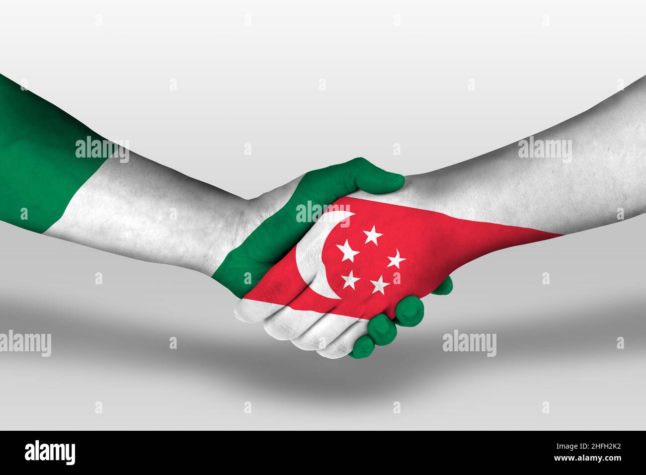 Handshake between singapore and nigeria flags painted on hands ...