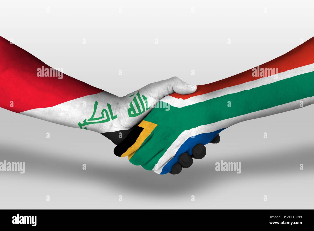 Handshake between south africa and iraq flags painted on hands ...