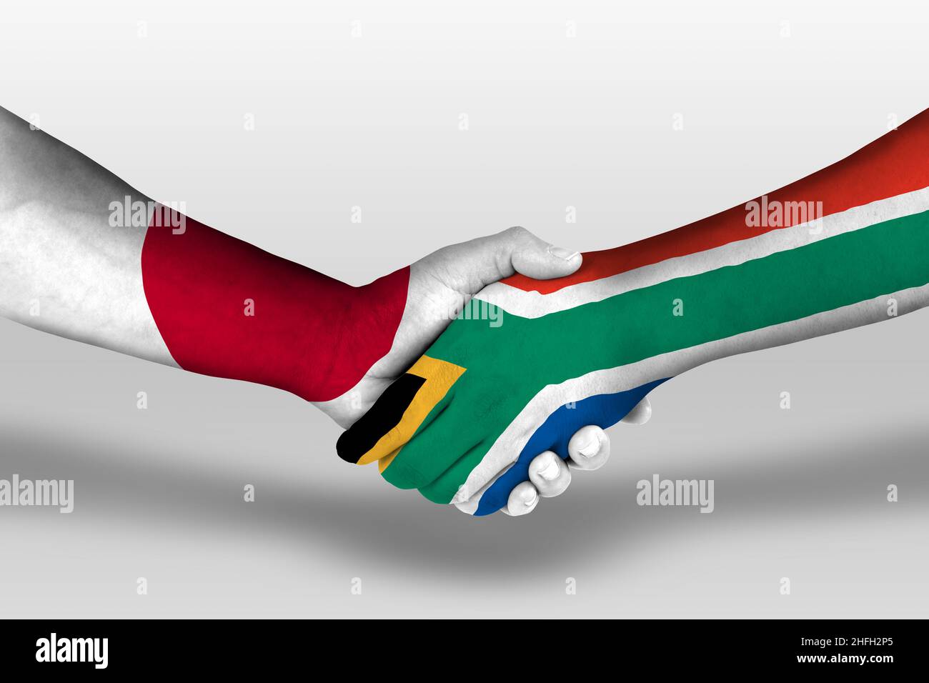 Handshake between south africa and japan flags painted on hands ...