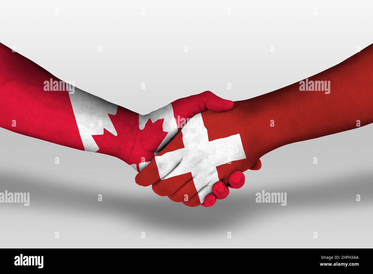 Handshake between switzerland and canada flags painted on hands ...