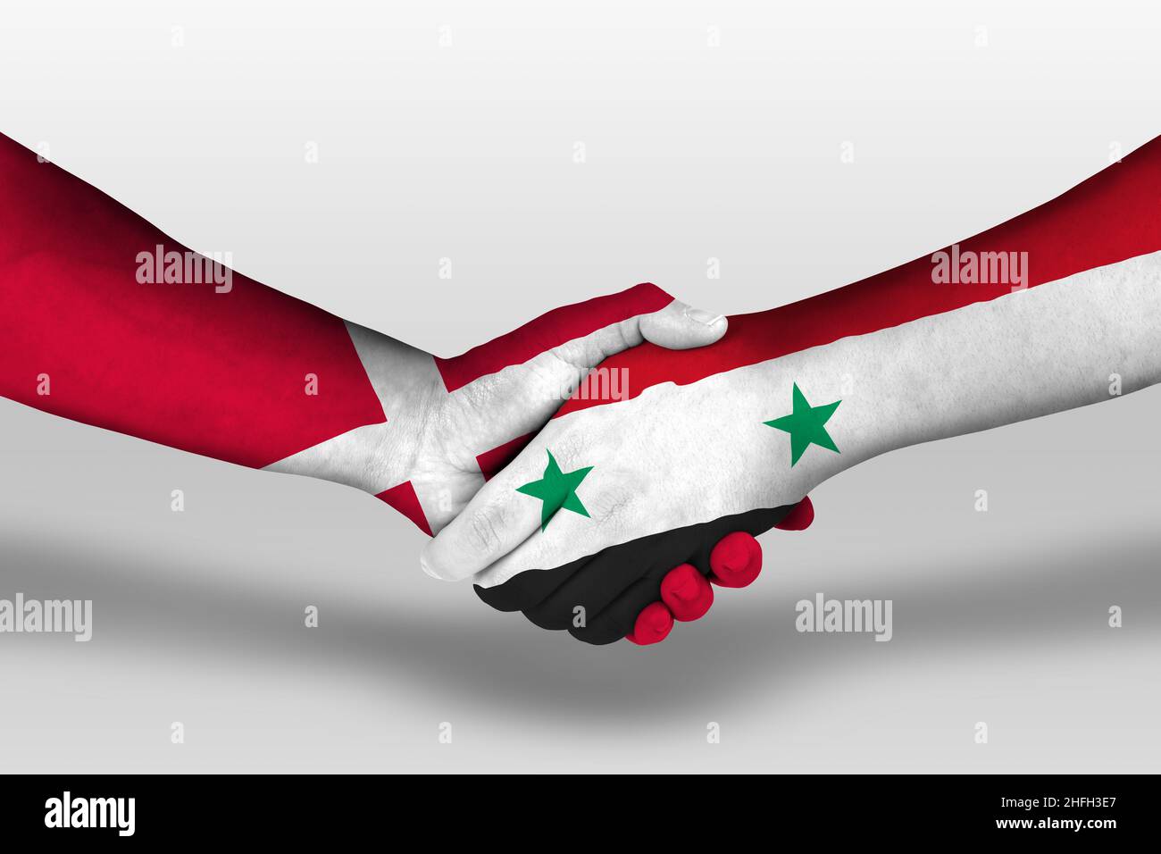 Handshake between syria and denmark flags painted on hands ...