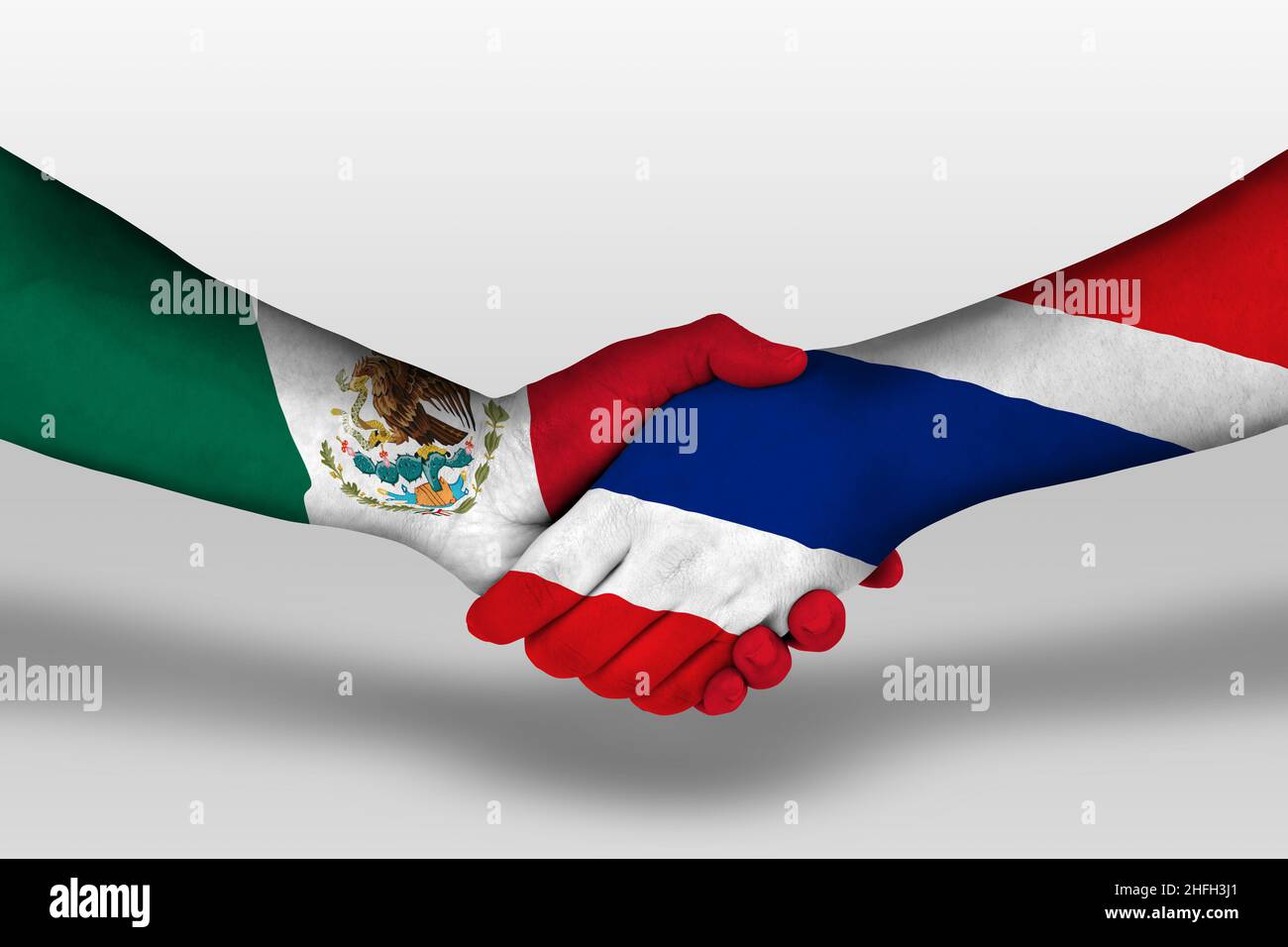 Handshake between thailand and mexico flags painted on hands ...