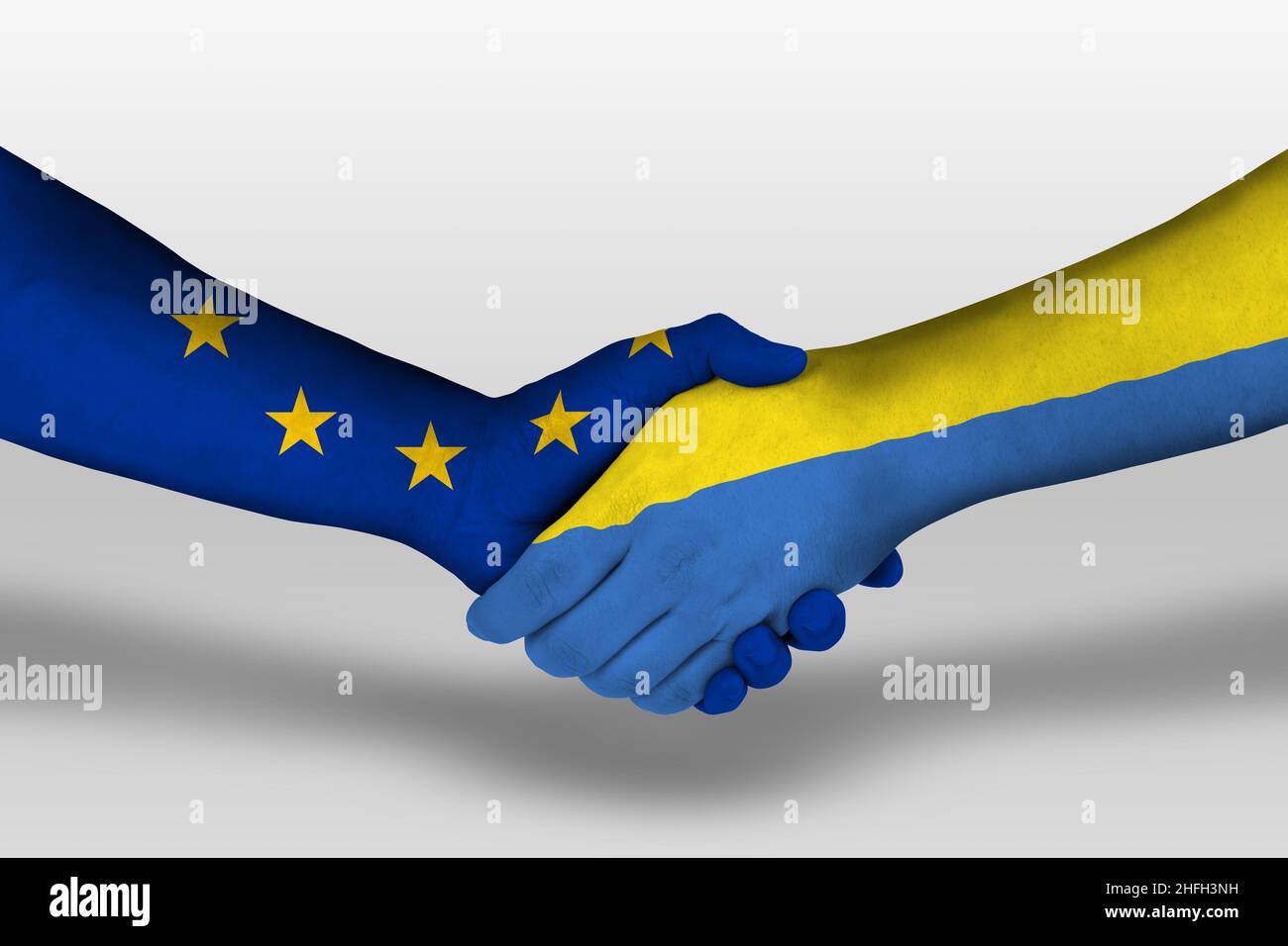 Handshake between ukraine and european union flags painted on hands ...