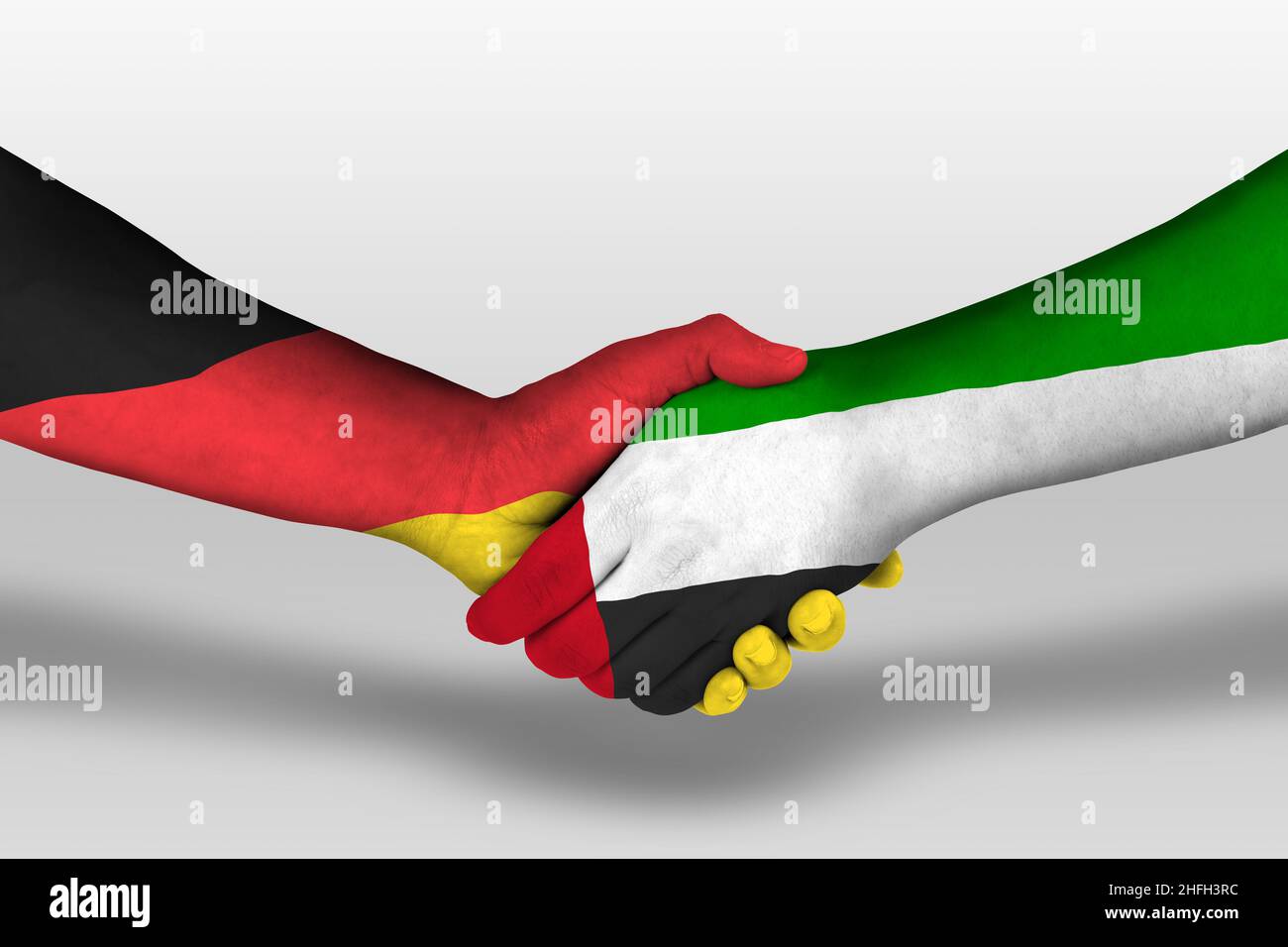 Handshake between united arab emirates and germany flags painted on ...