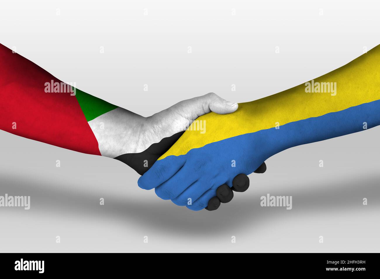 Handshake between ukraine and united arab emirates flags painted on ...