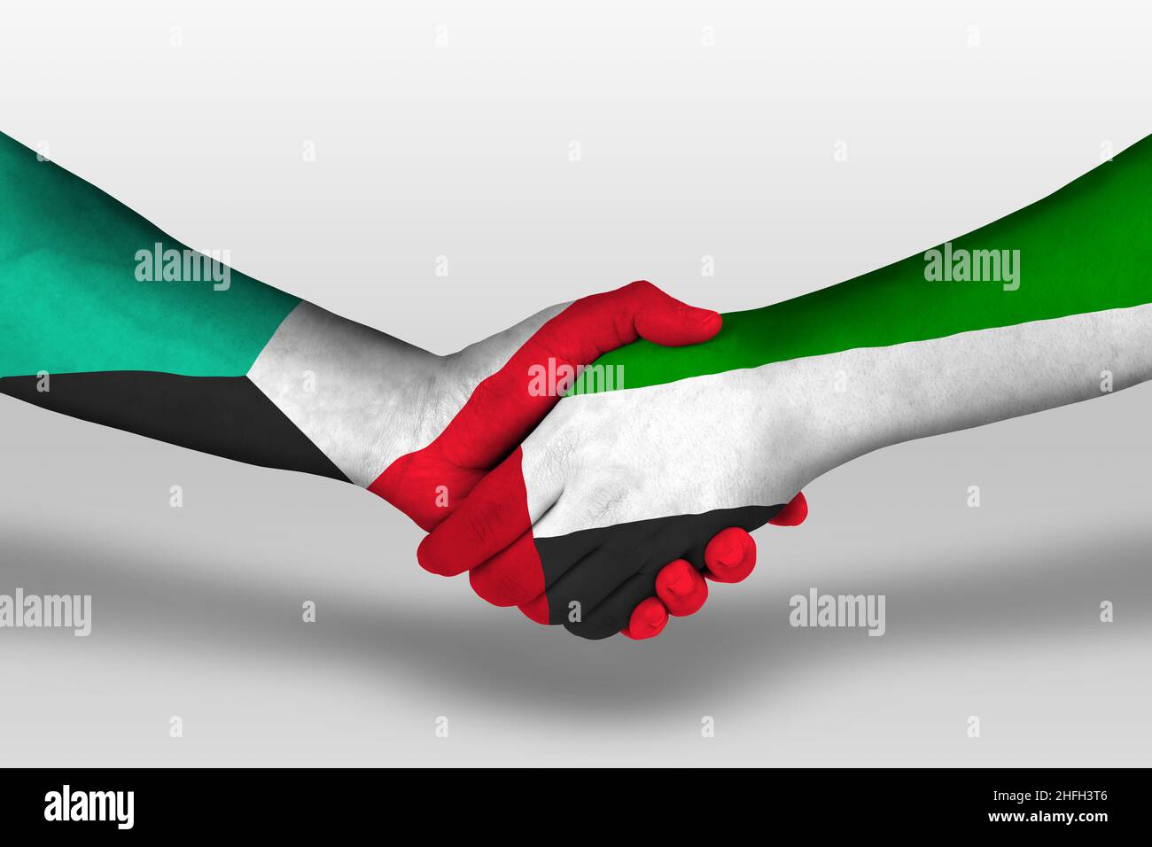 Handshake between united arab emirates and kuwait flags painted on ...