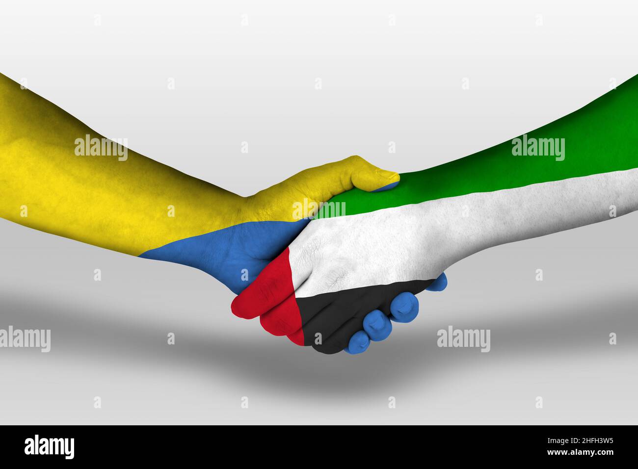 Handshake between united arab emirates and ukraine flags painted on ...