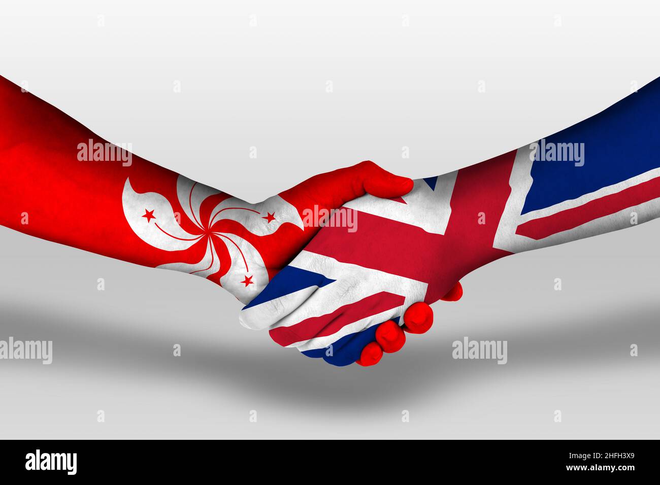 Handshake between united kingdom and hong kong flags painted on hands ...