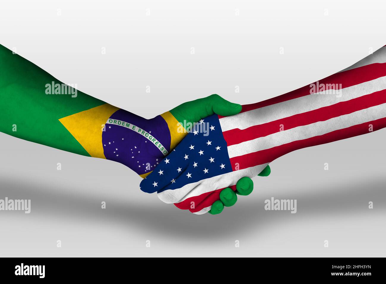 Handshake between united states of america and brazil flags painted on ...