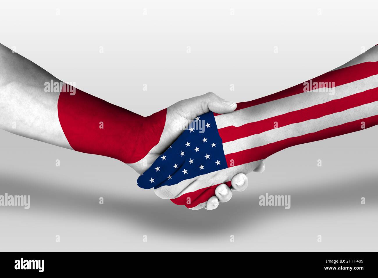 Handshake between united states of america and japan flags painted on ...