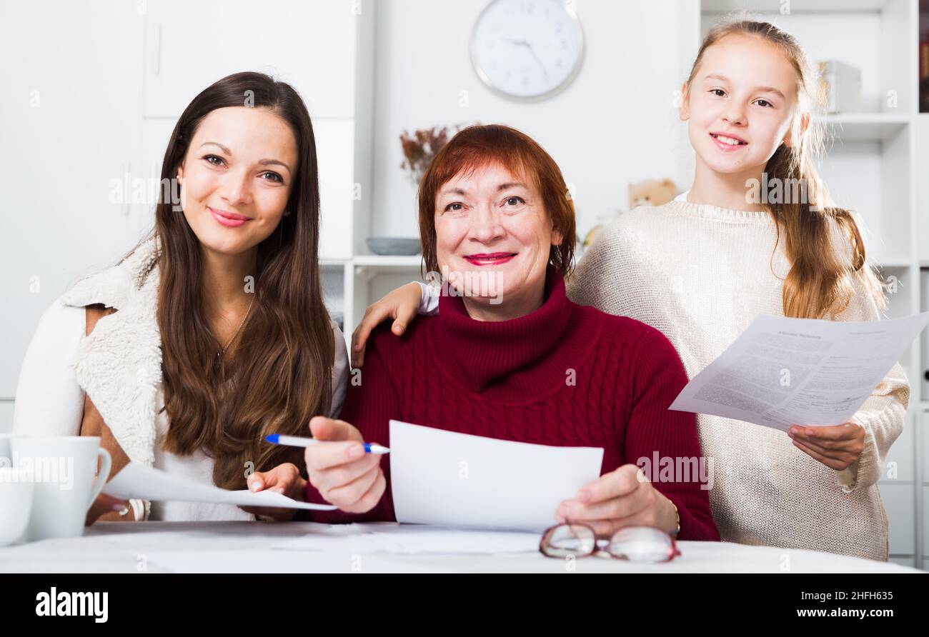 Happy family working with papers Stock Photo - Alamy