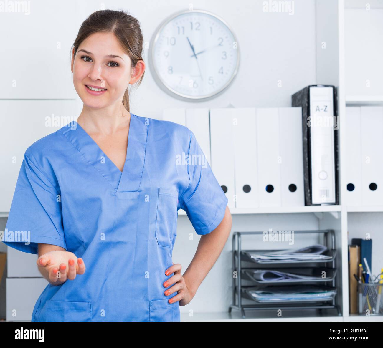 Female doctor making welcome gesture Stock Photo - Alamy