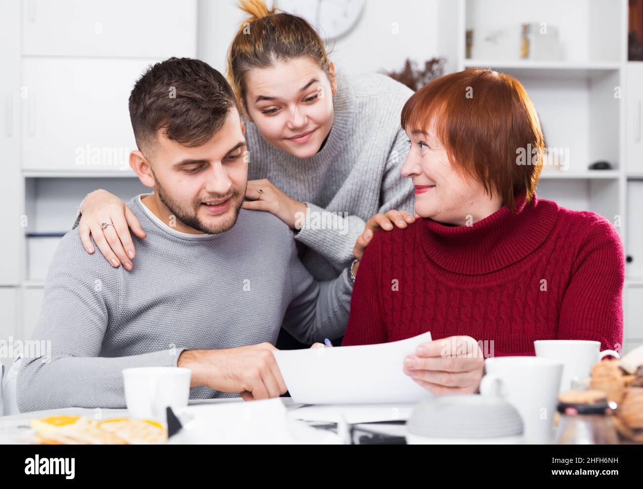 Cheerful family with papers Stock Photo - Alamy