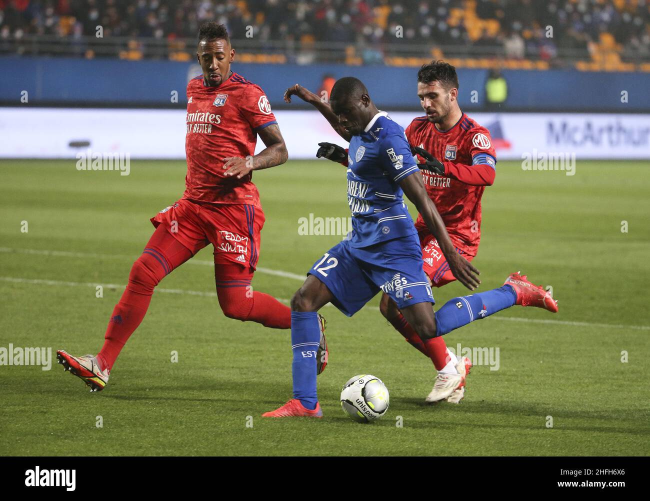 Abdu Conte of Troyes between Jerome Boateng and Leo Dubois of Lyon ...