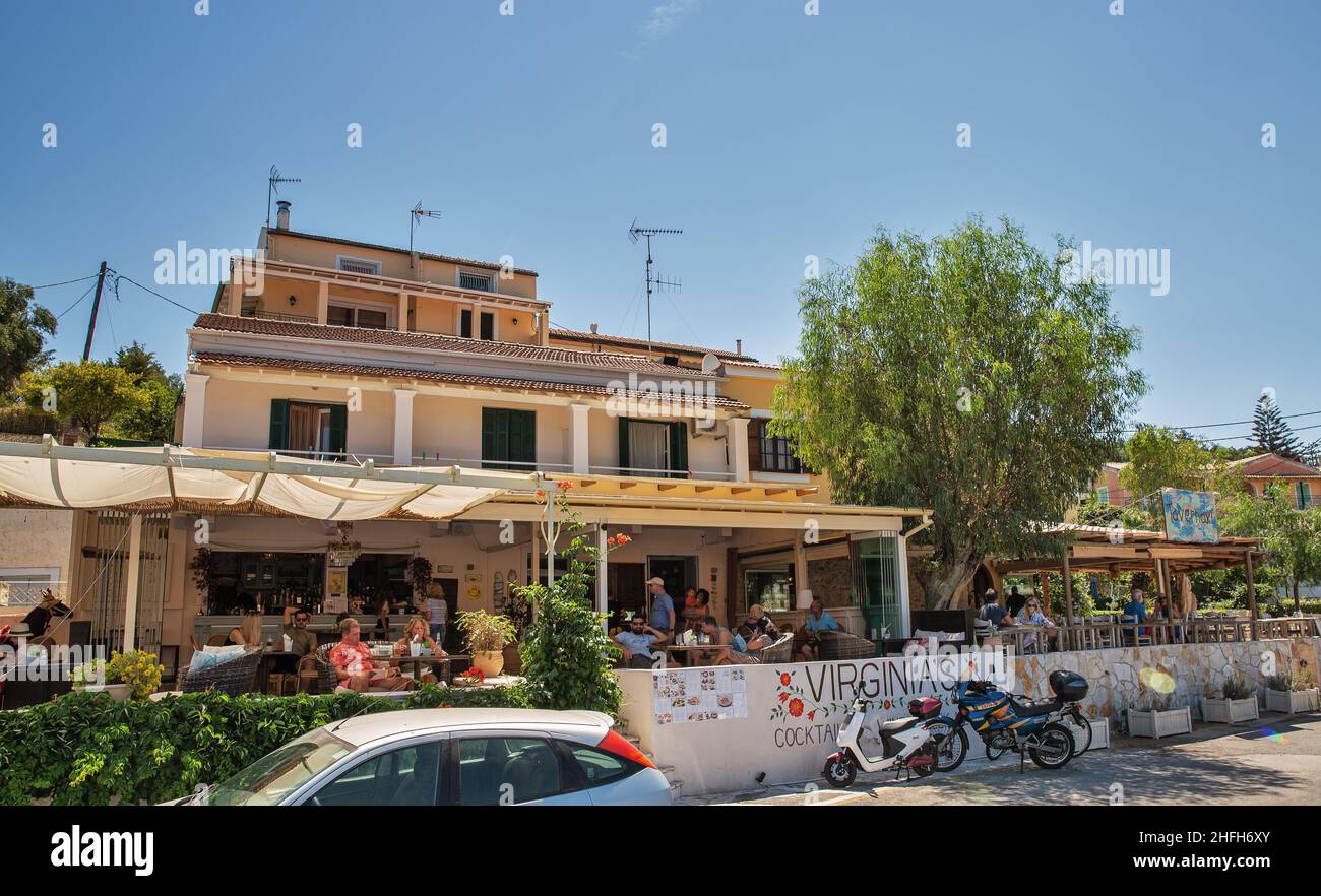 Kassiopi, Corfu, Greece - August 07, 2021: People visit cafe and ...