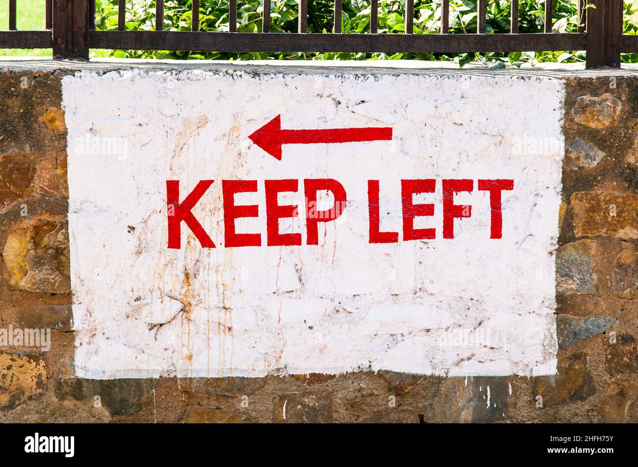 keep left sign painted at a wall in india Stock Photo - Alamy