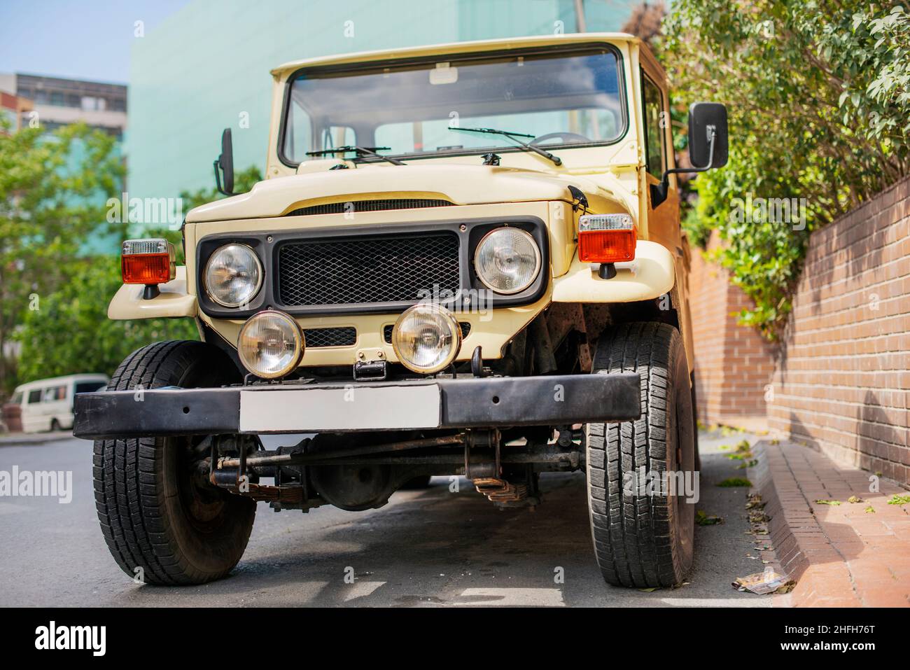 cream colored four by four car parking on the street Stock Photo - Alamy