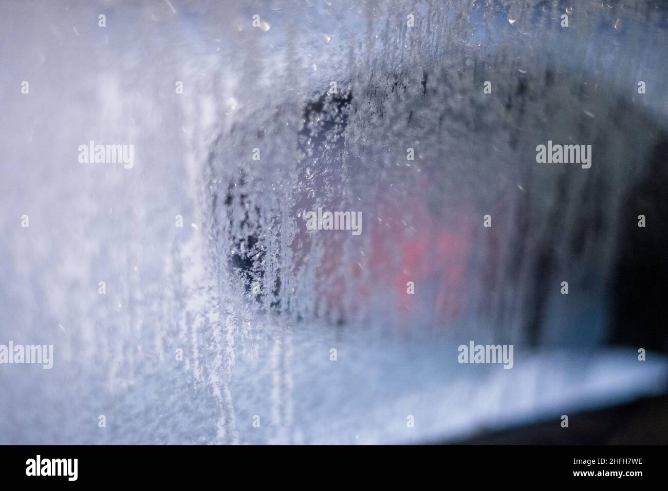 Car window under ice during cold winter weather. Dangerous traffic ...