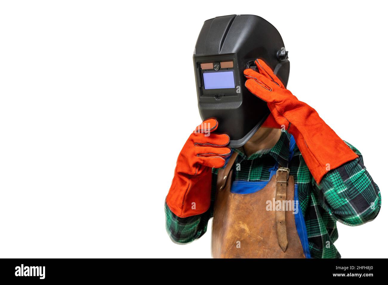 Welder in a protective suit, gloves, taking off his welding mask, Close ...