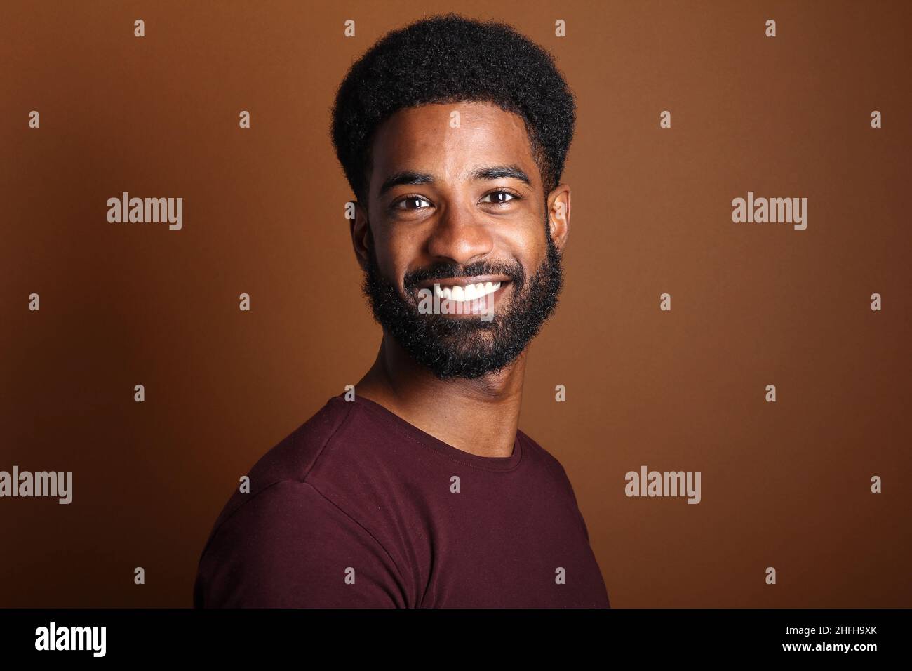 Portrait of a beautiful happy man in front of a colored background ...