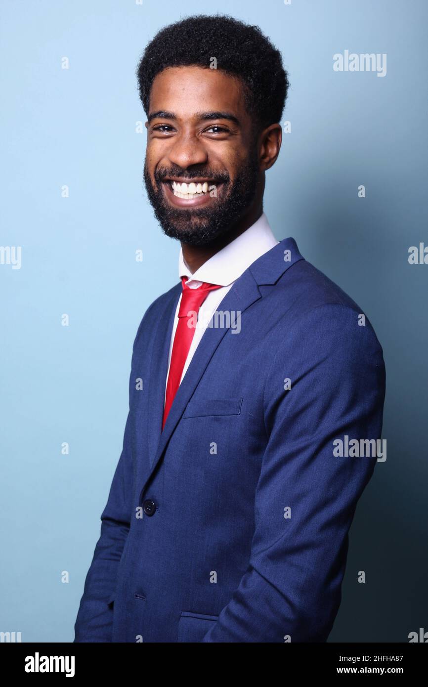 Portrait of a beautiful happy man in front of a colored background ...