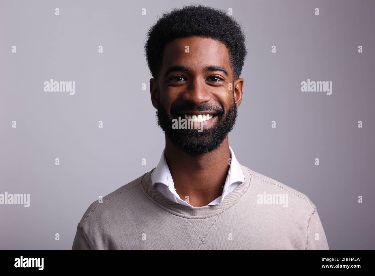 Portrait of a beautiful happy man in front of a colored background ...