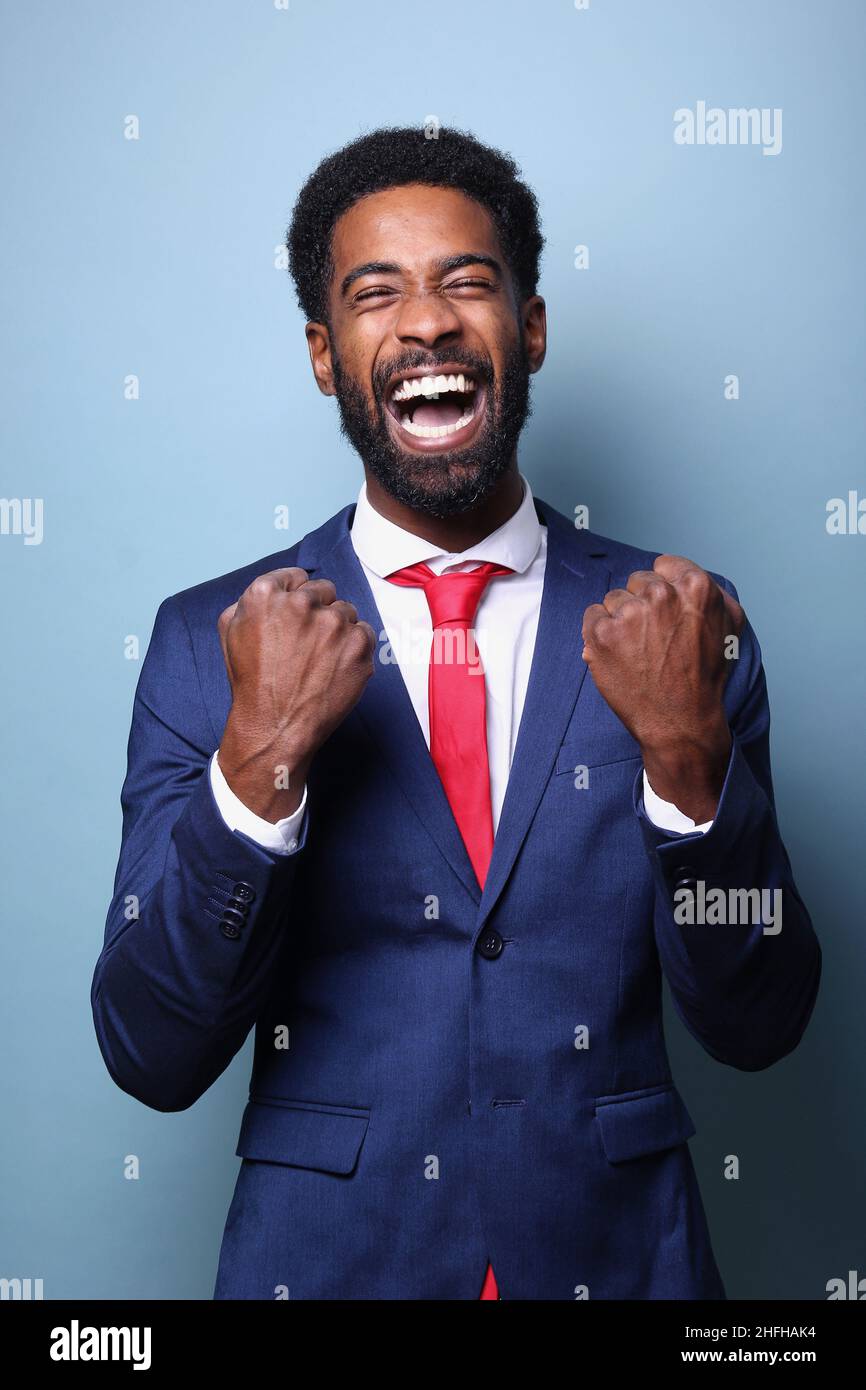 Portrait of a beautiful happy man in front of a colored background ...