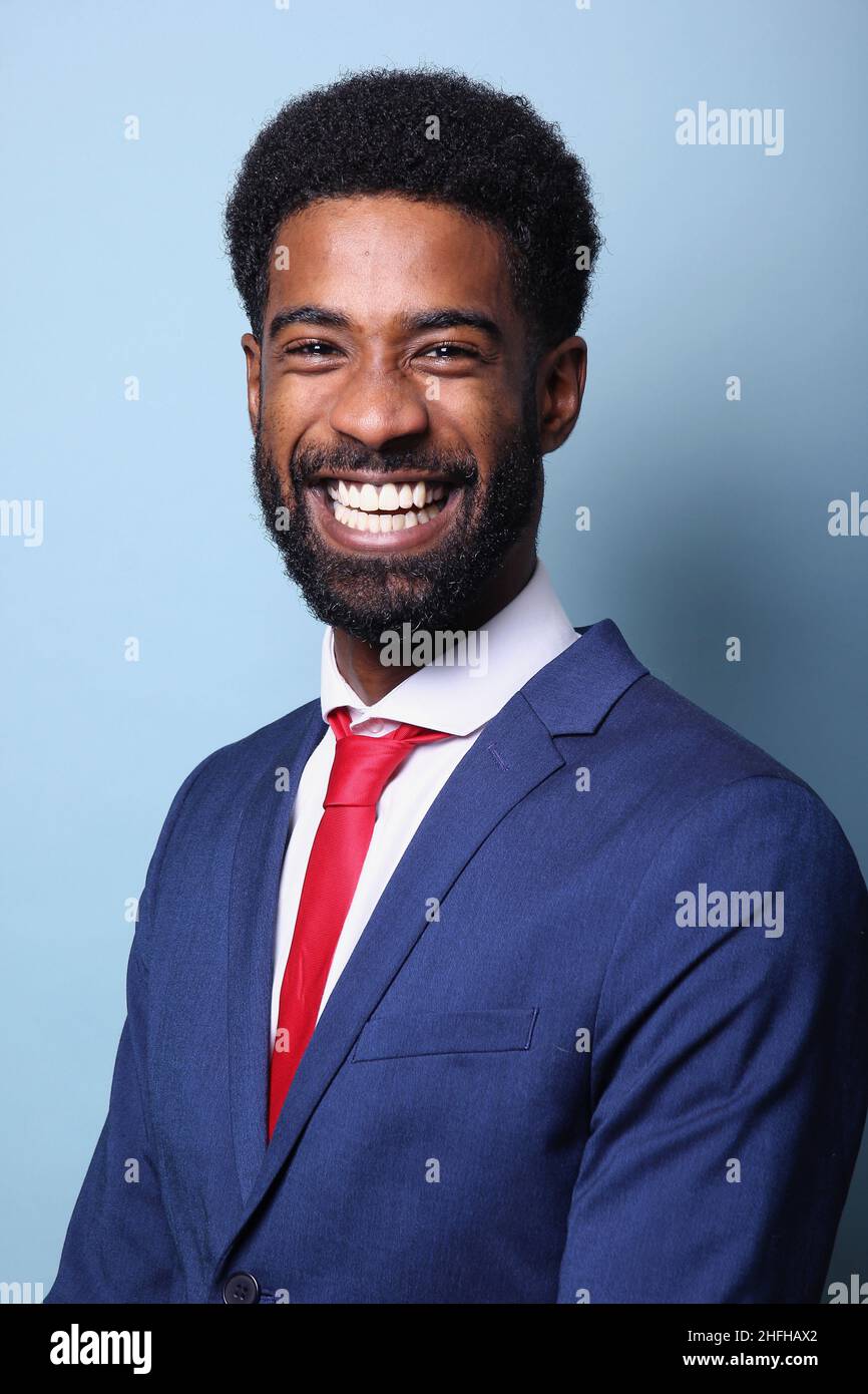 Portrait of a beautiful happy man in front of a colored background ...