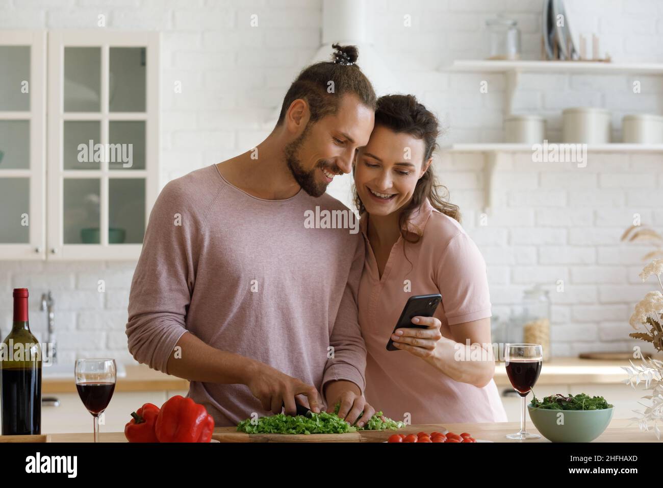 Bonding family couple cooking on weekend, using cellphone Stock Photo ...