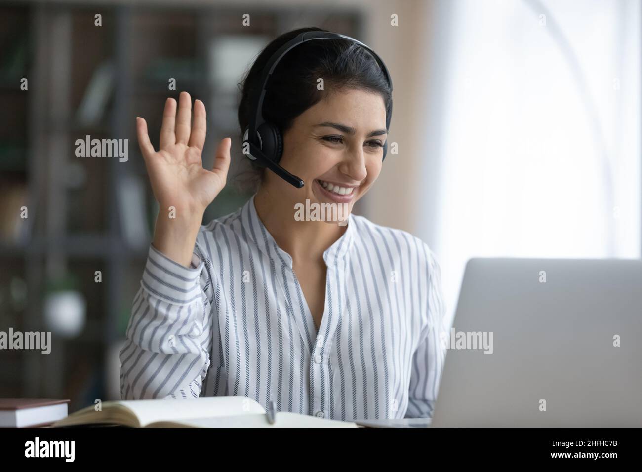 Happy attractive millennial Indian woman starting video call meeting ...