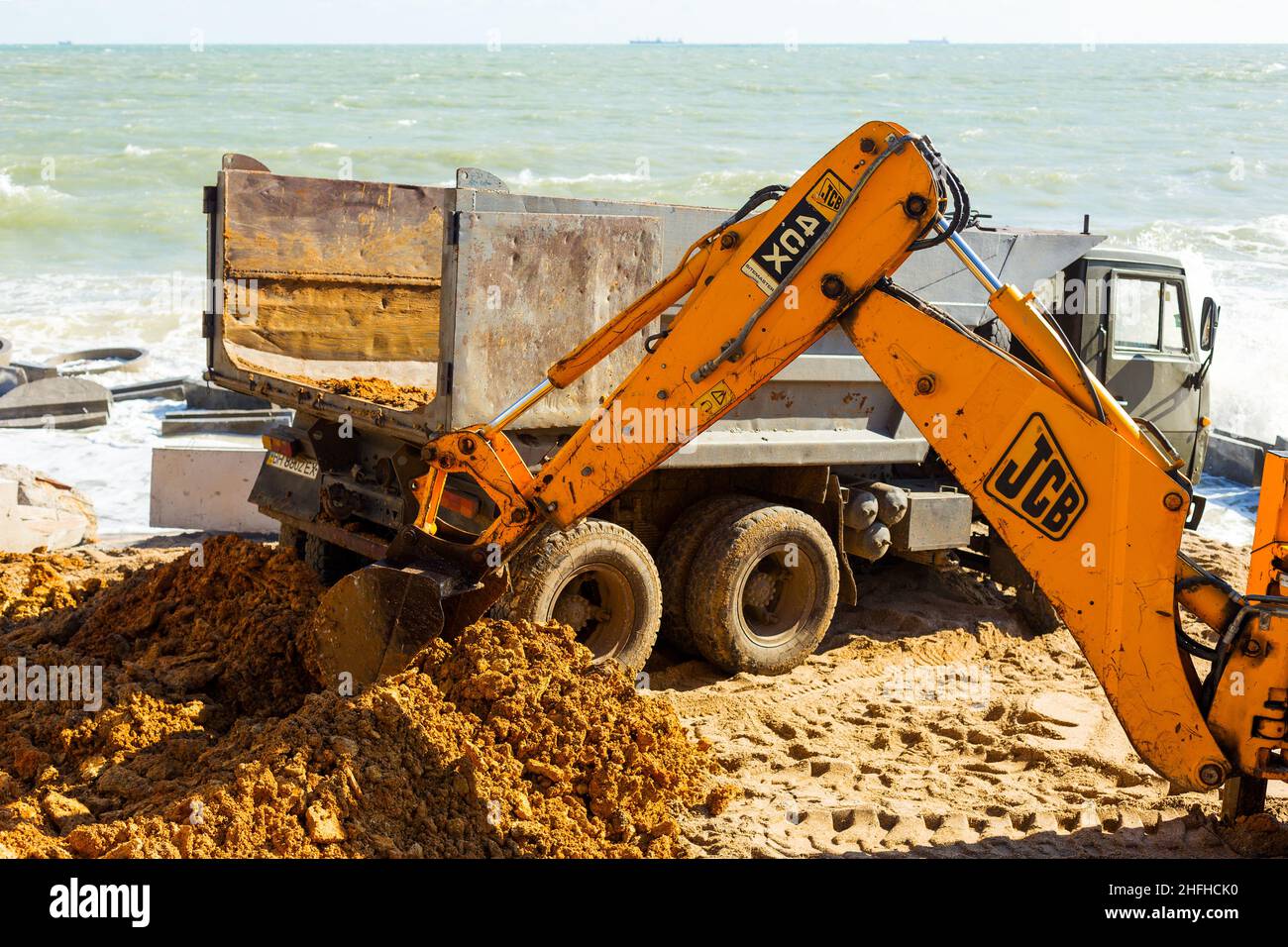 ODESSA, UKRAINE -17 October 2016: Excavator digs sand on a sea beach ...