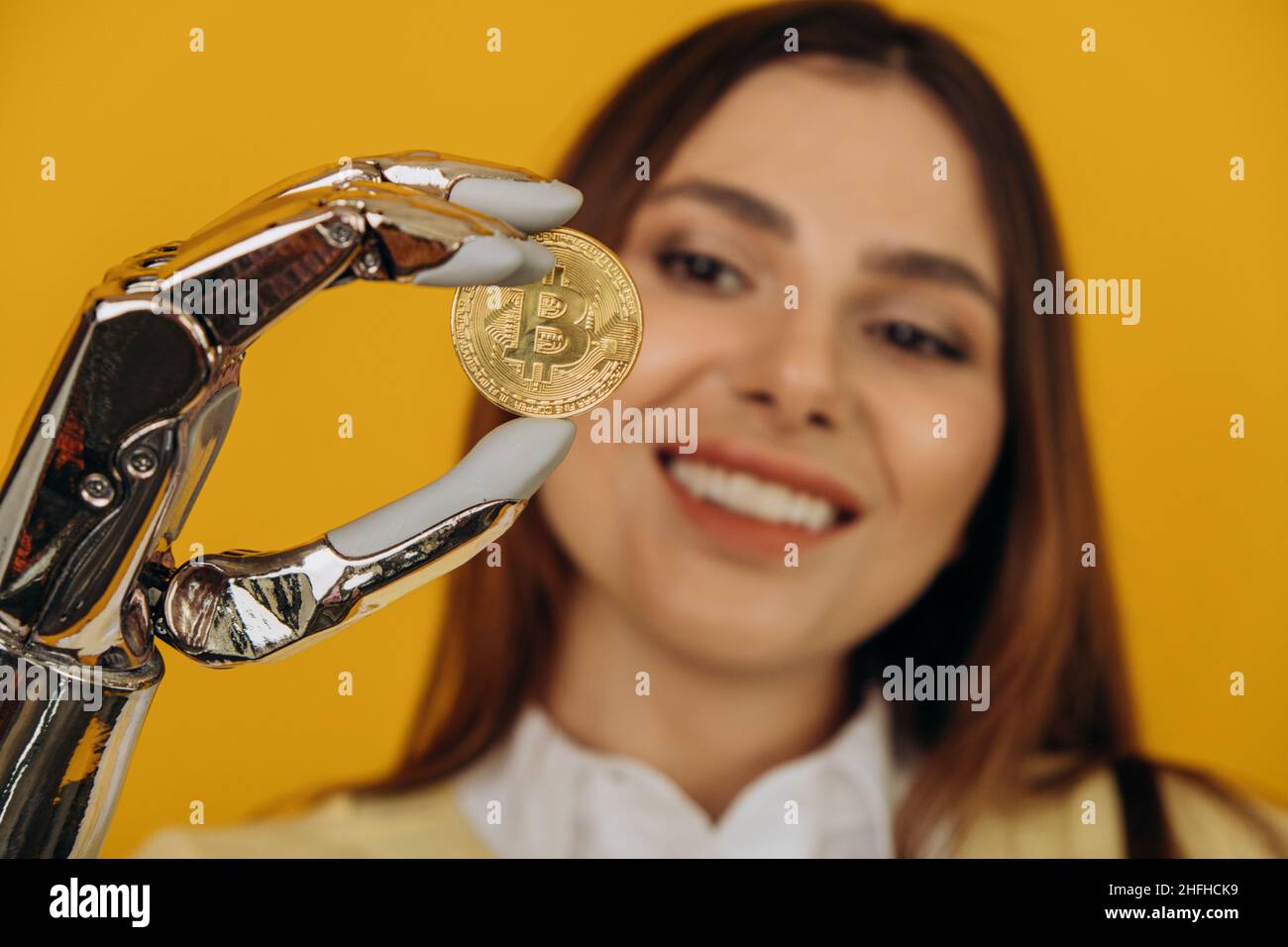 Lady with modern shiny metal bionic arm holds large golden bitcoin ...