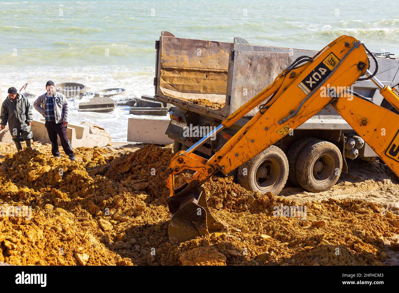 ODESSA, UKRAINE -17 October 2016: Excavator digs sand on a sea beach ...