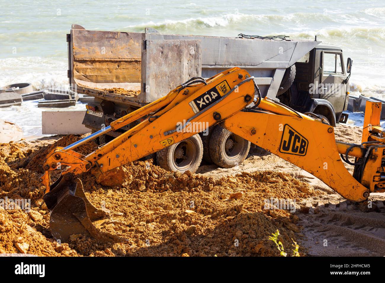 ODESSA, UKRAINE -17 October 2016: Excavator digs sand on a sea beach ...