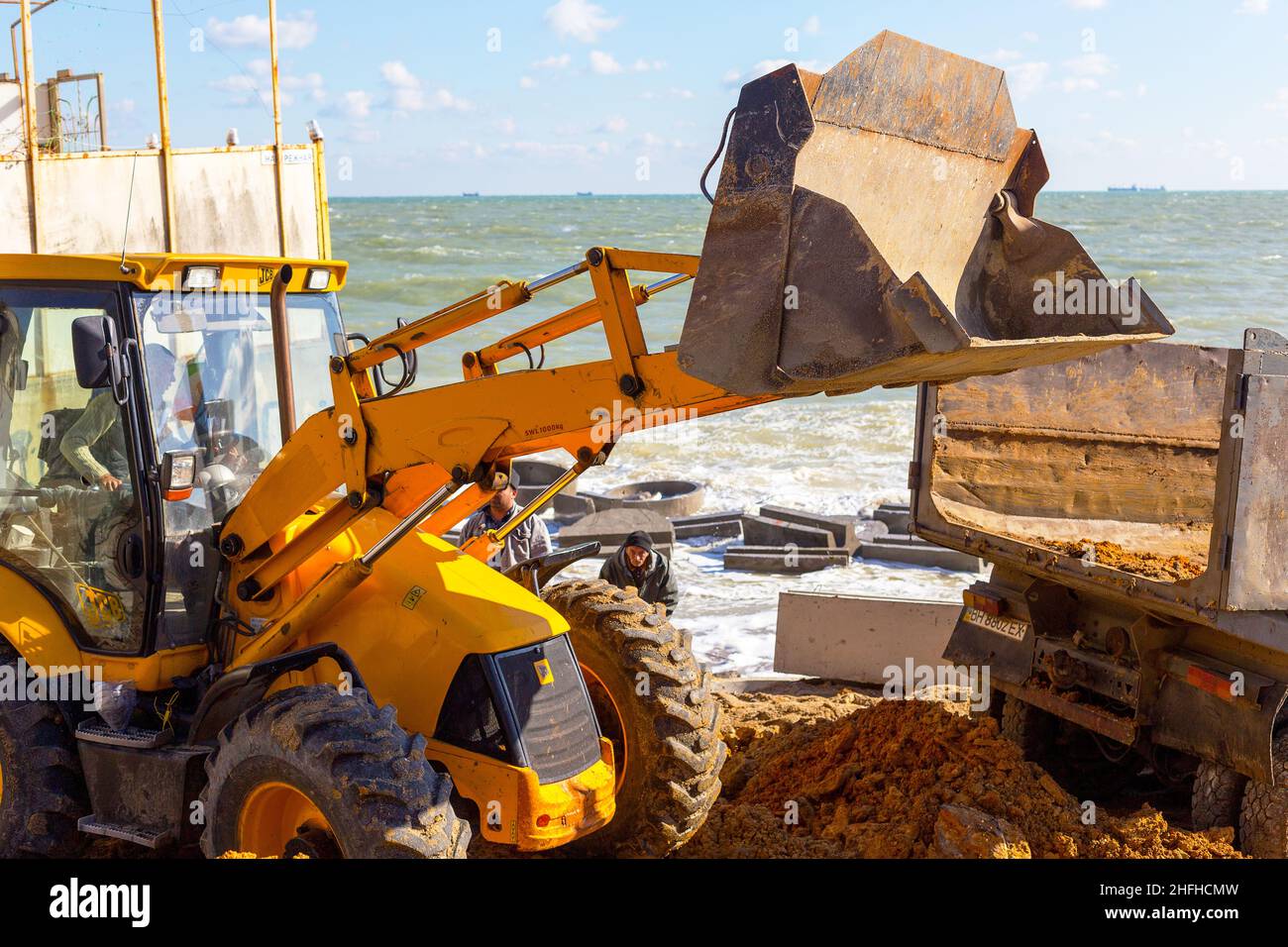 ODESSA, UKRAINE -17 October 2016: Excavator digs sand on a sea beach ...