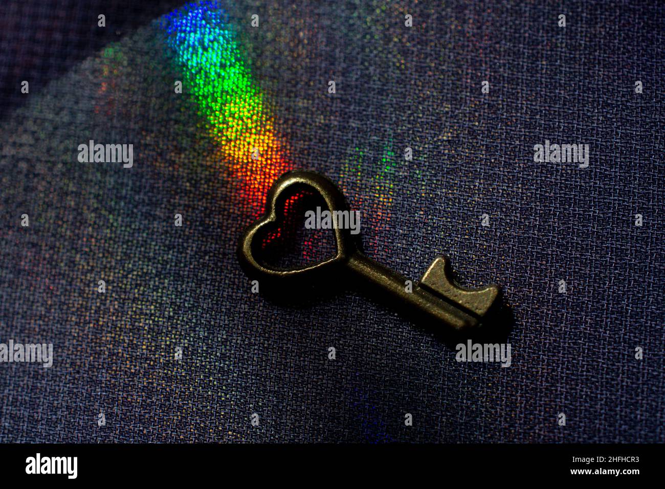 Vintage key. .Antique key. Retro key on colorful fabric background ...