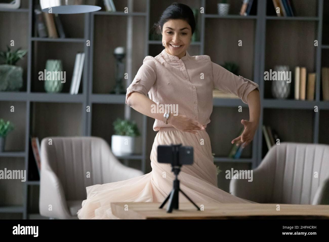 Happy young Indian woman recording video on cellphone Stock Photo - Alamy