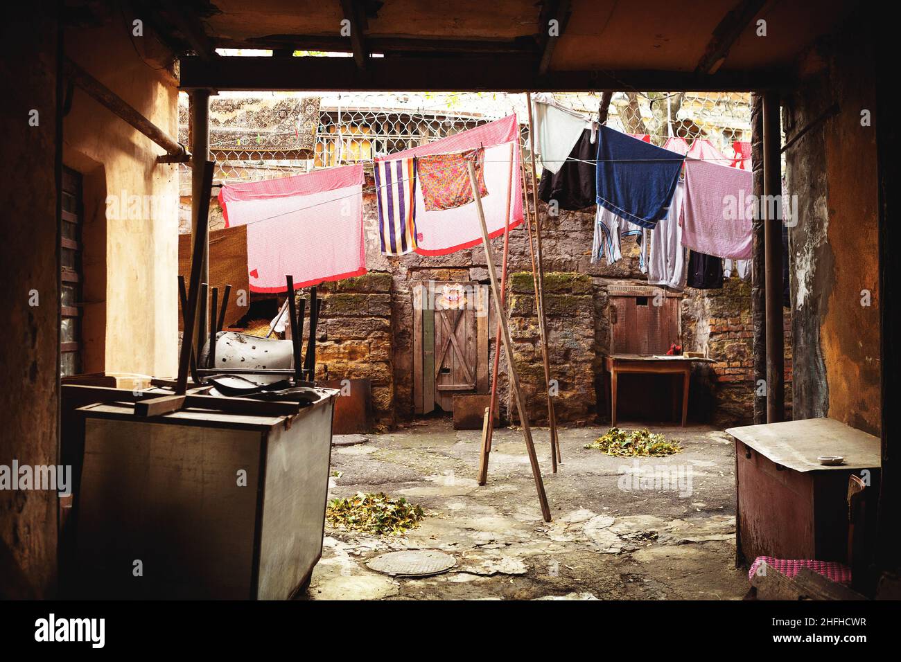 Wash clothes hanging on a clothesline in a poor residential quarter of ...