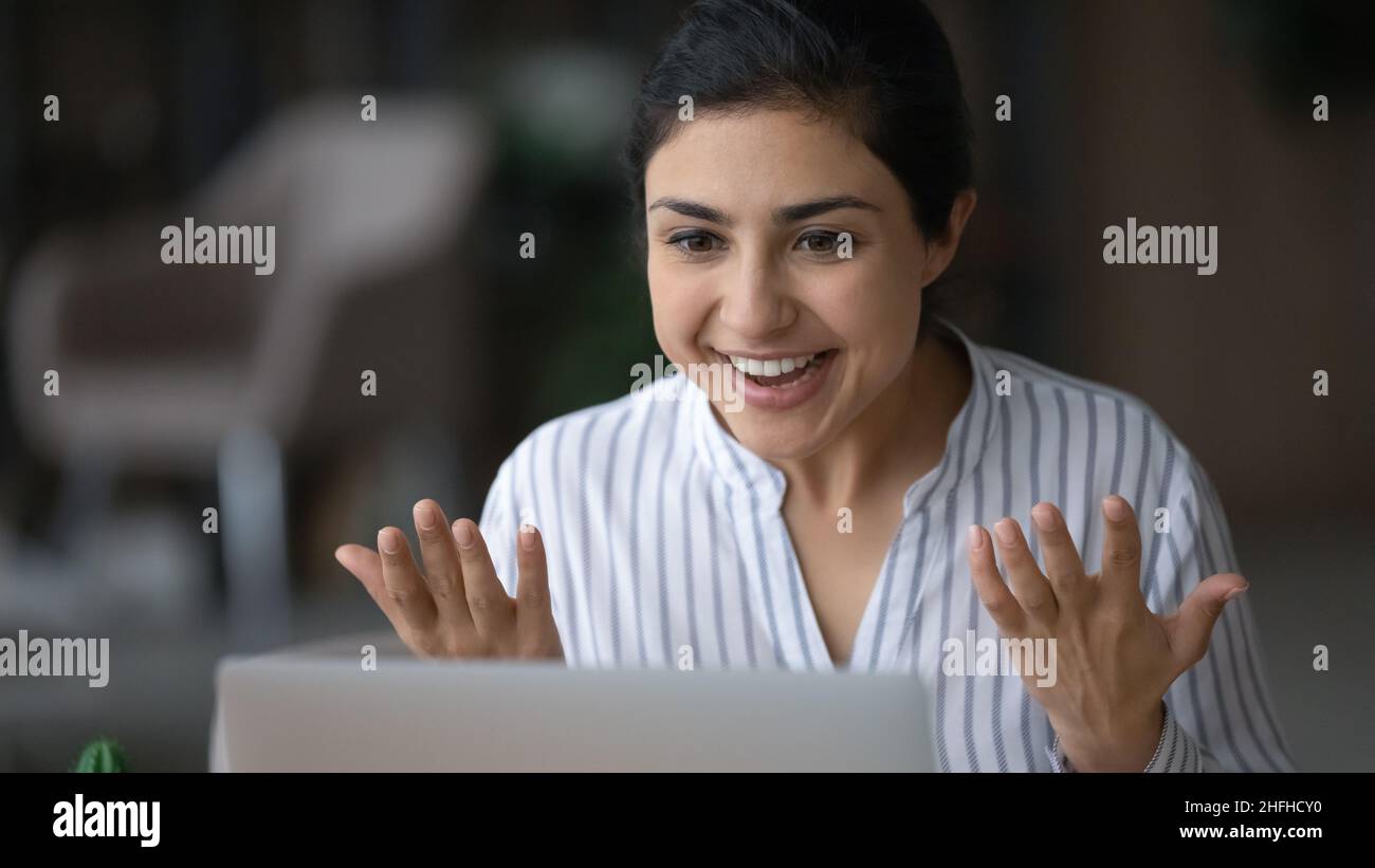 Overjoyed young Indian woman reading email with good news Stock Photo ...