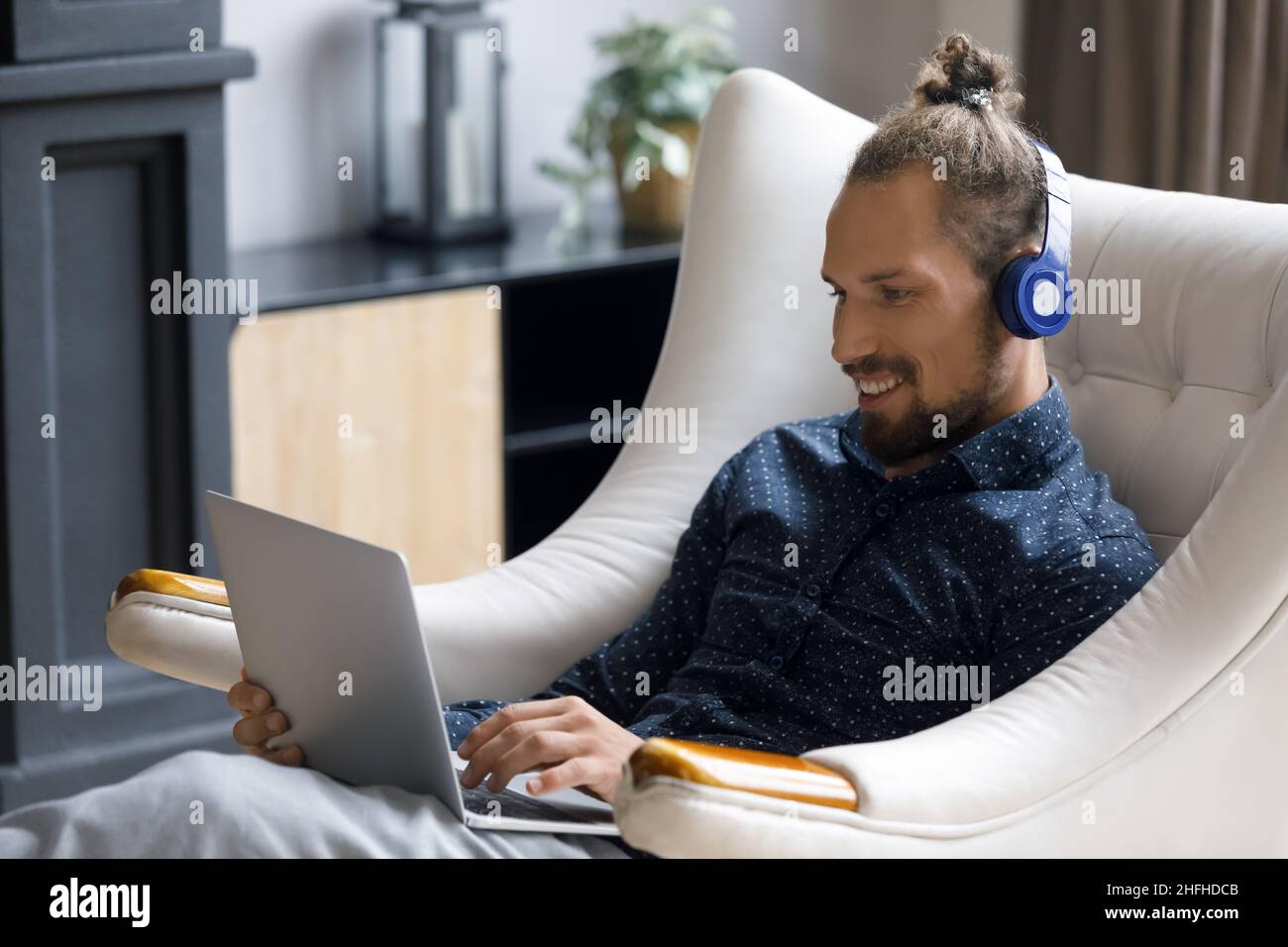 Happy relaxed young man in headphones using computer Stock Photo - Alamy