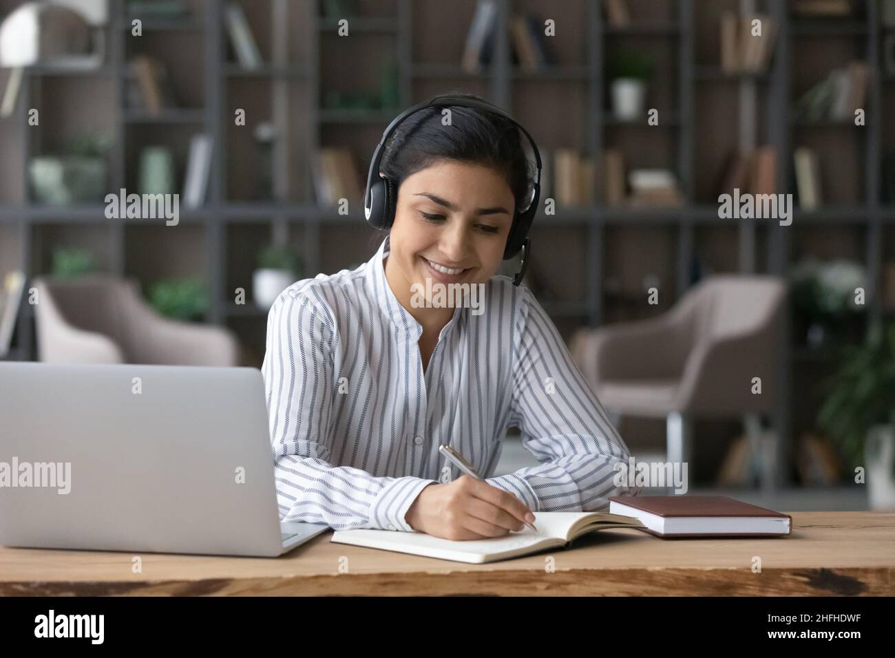 Happy beautiful Indian woman studying on online courses Stock Photo - Alamy